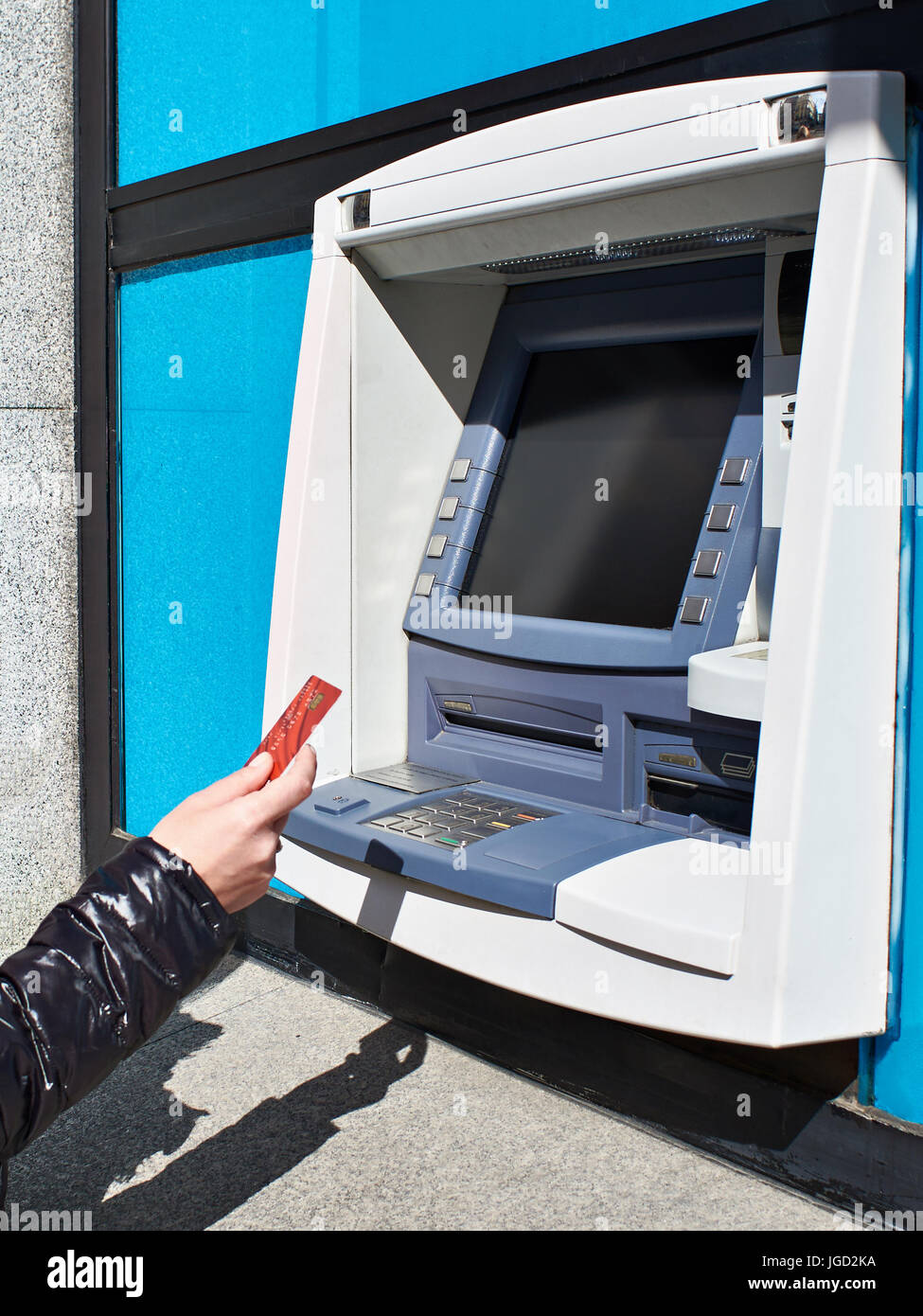 Hand with a bank card at the ATM Stock Photo - Alamy