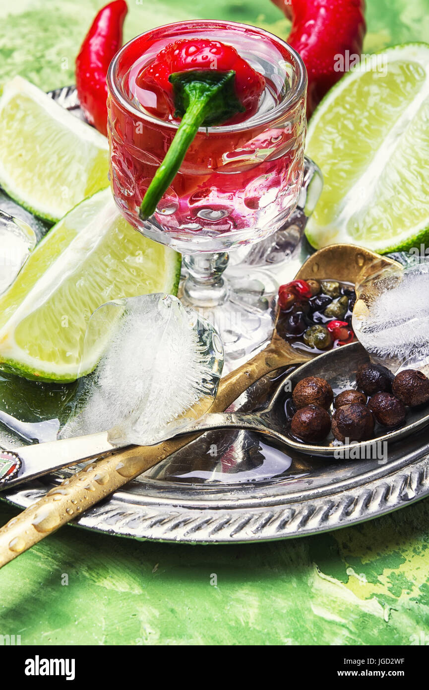 glass of pepper vodka and red mexican chili pepper Stock Photo - Alamy