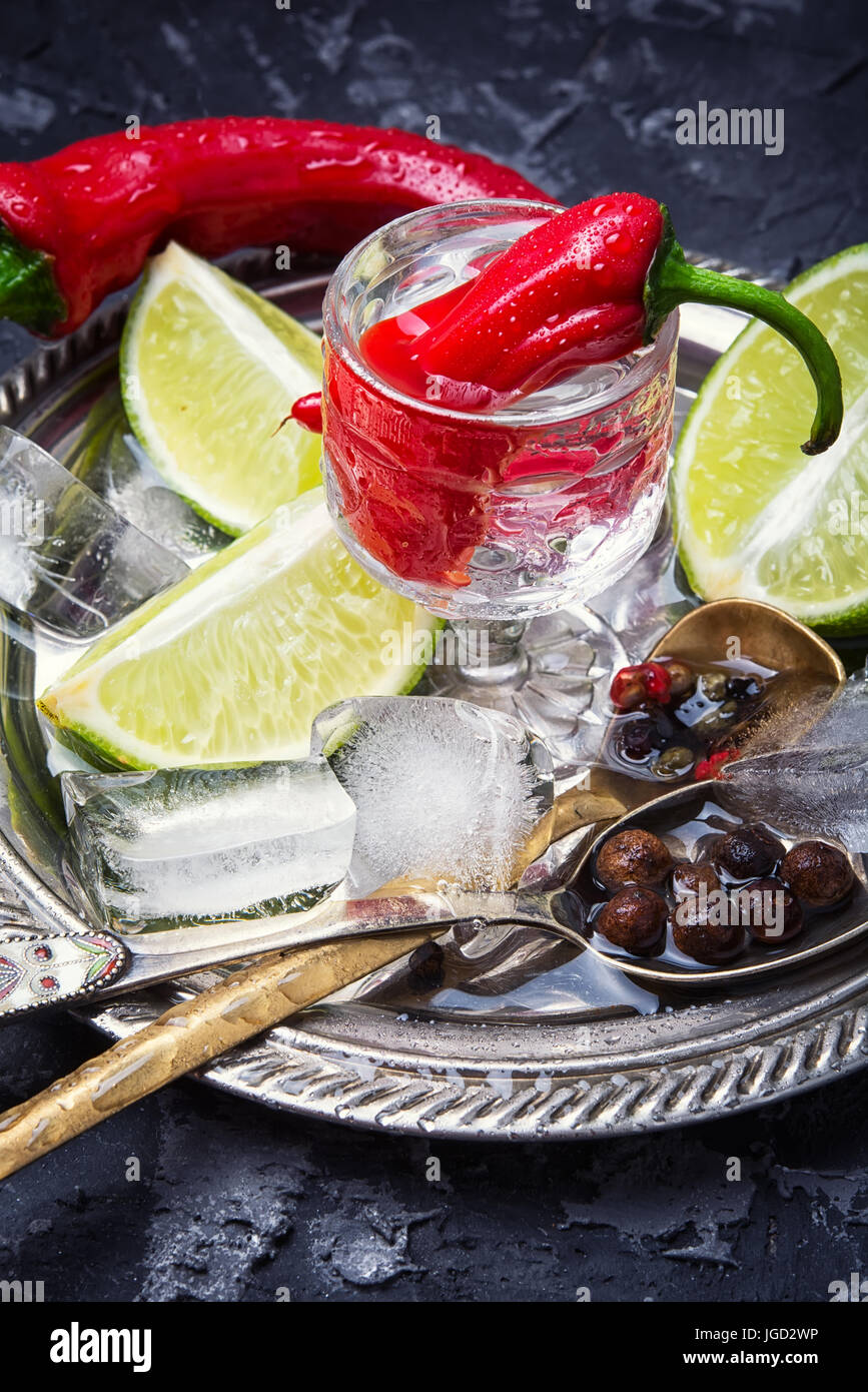 glass of pepper vodka and red mexican chili pepper Stock Photo - Alamy