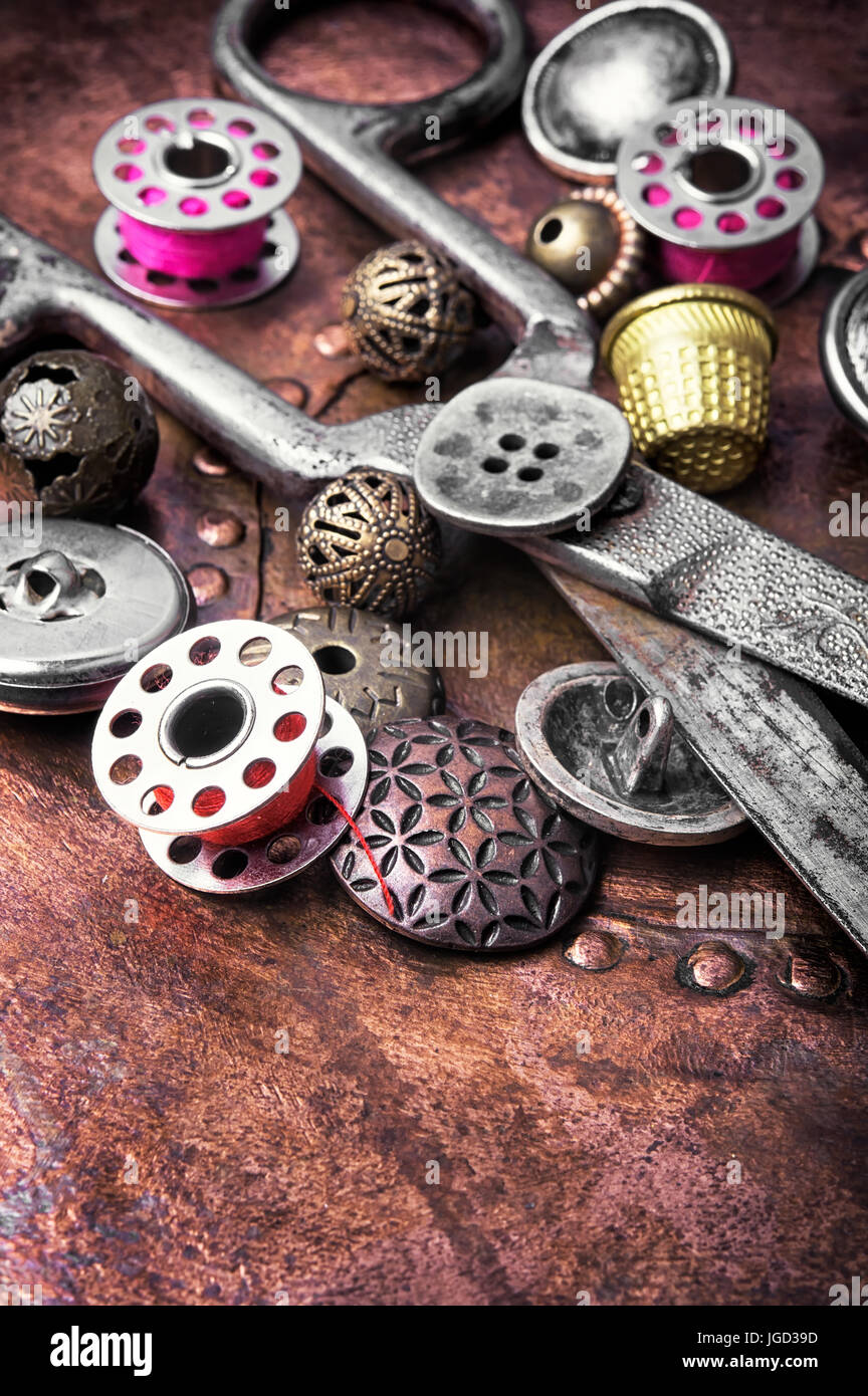 metal sewing button and thread coil on copper retro background Stock ...