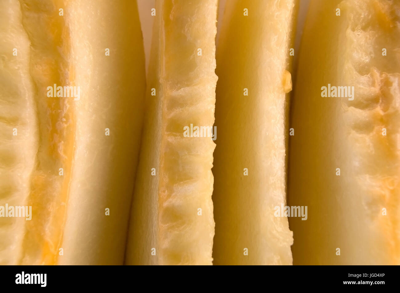 Sliced pieces of melon texture yellow background Stock Photo - Alamy