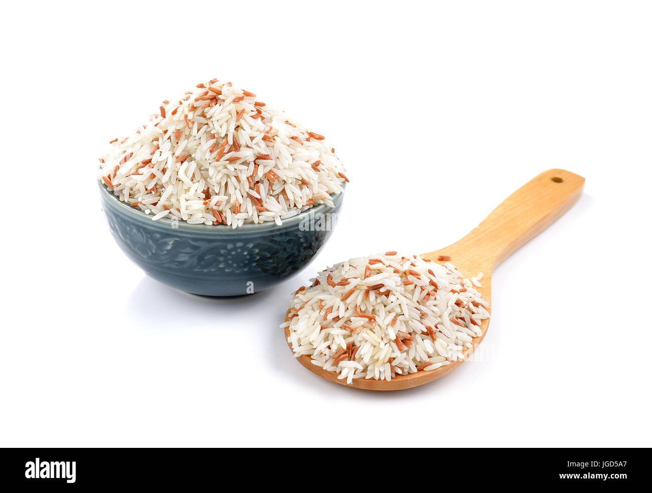 rice in a ceramic cup and wooden spoon isolated on white background ...