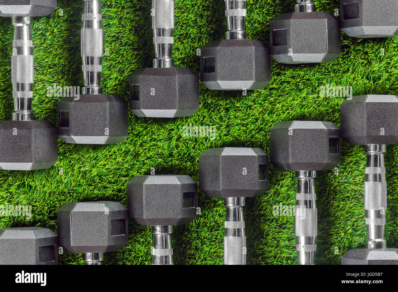 Dumbbells on the grass. Pattern, background, texture Stock Photo - Alamy
