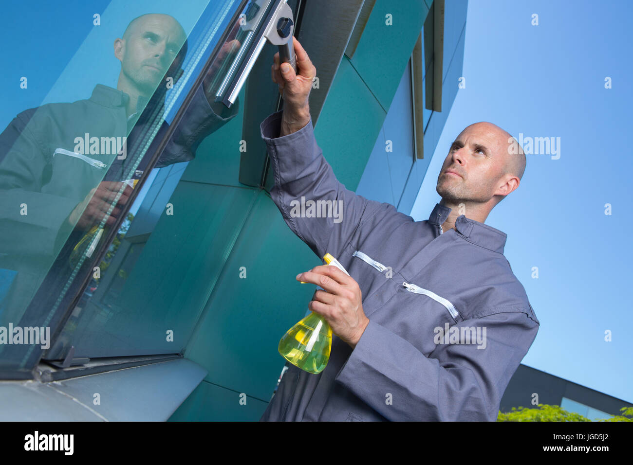 window cleaning employee with work tools Stock Photo - Alamy