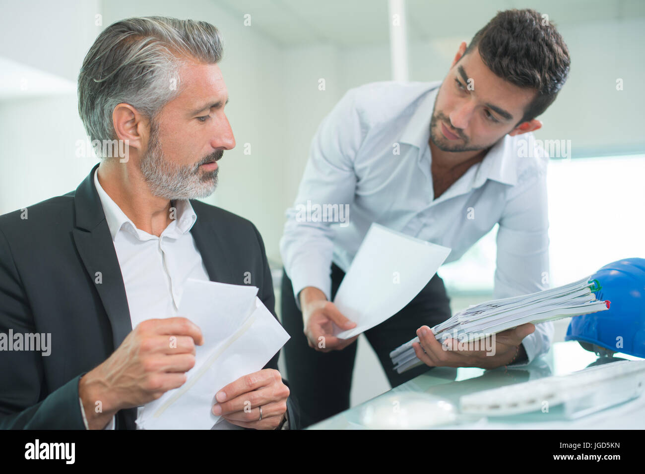 businessman and colleague writing on paper in the office Stock Photo ...