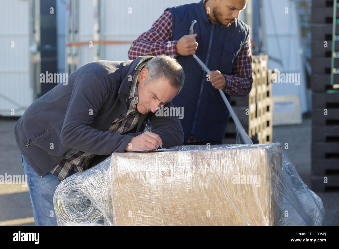 male deliverer with boxes outdoors Stock Photo - Alamy
