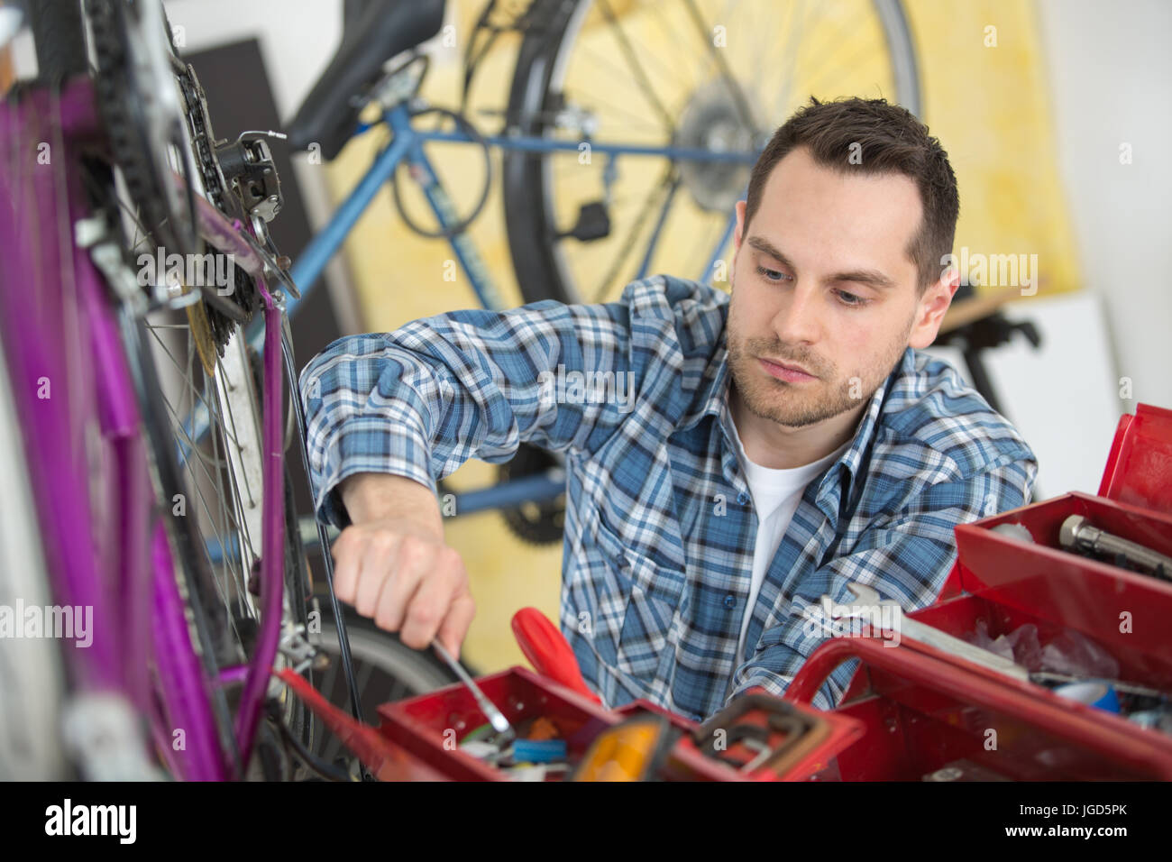 man repairing bike in his workshop Stock Photo - Alamy