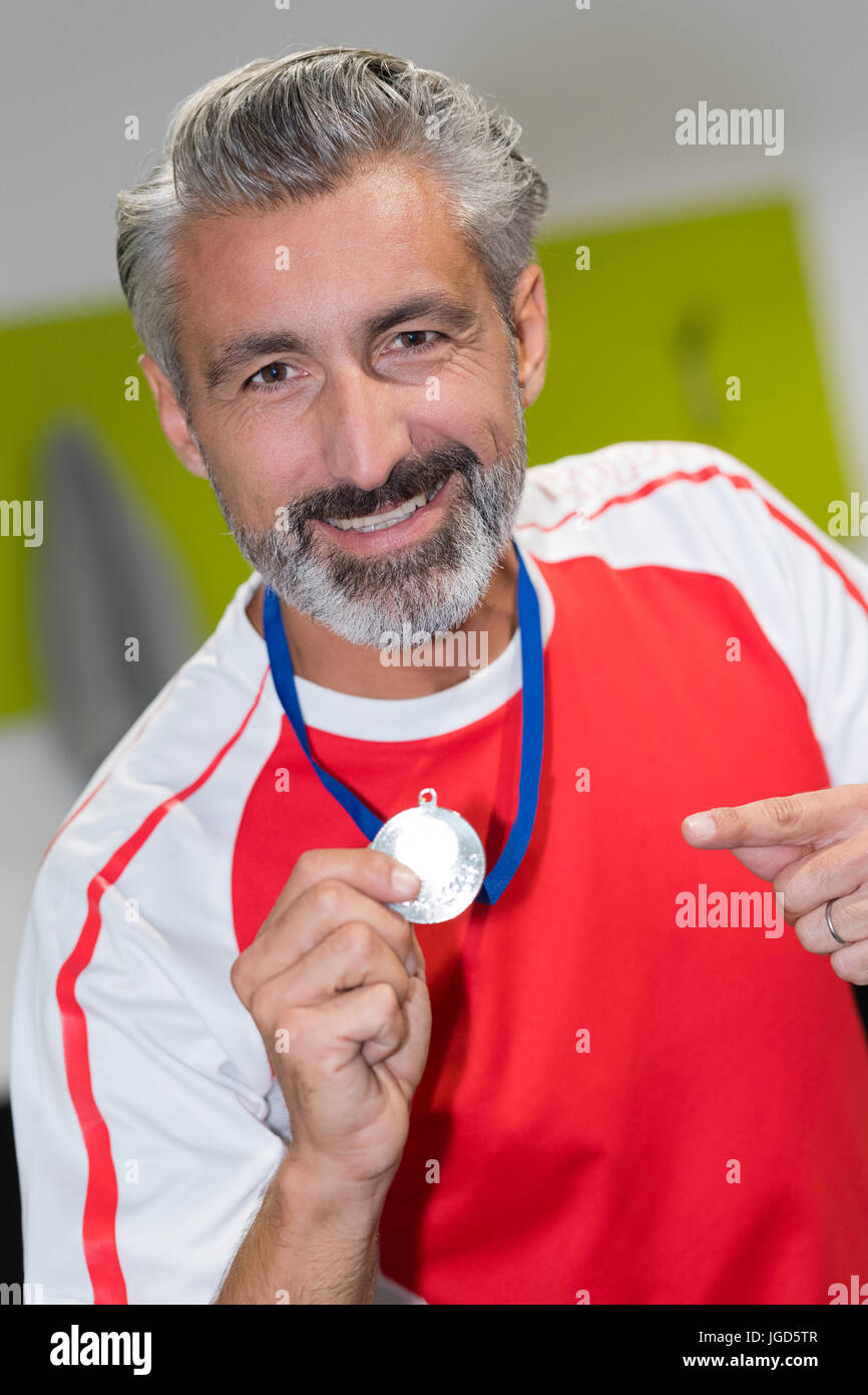 man holding a gold medal winner in a competition Stock Photo - Alamy