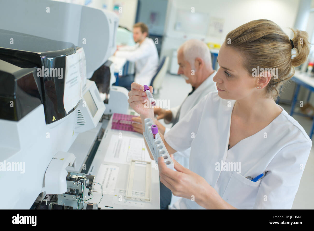a young chemist holding test tube with liquid Stock Photo - Alamy