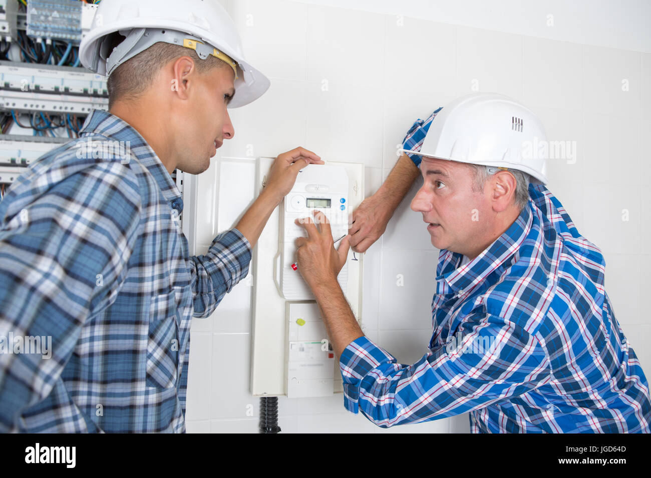 electrician training an apprentice Stock Photo - Alamy