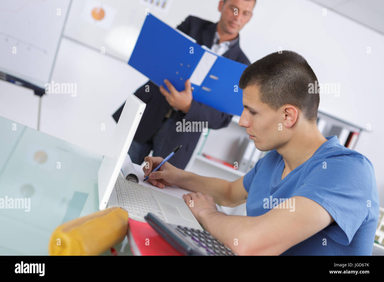 male home tutor helping boy with studies Stock Photo - Alamy