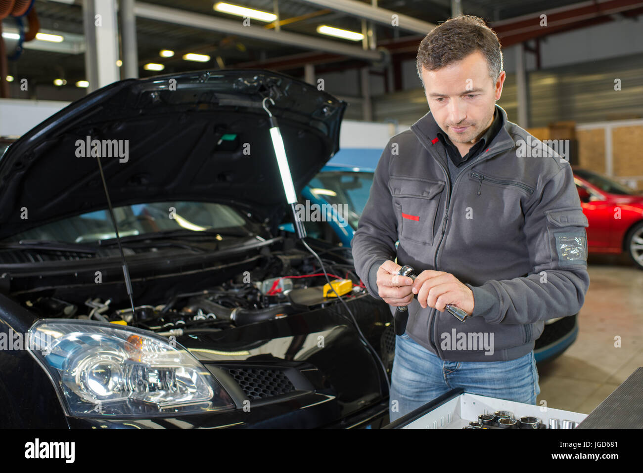 car mechanic working with tool in service workshop Stock Photo - Alamy