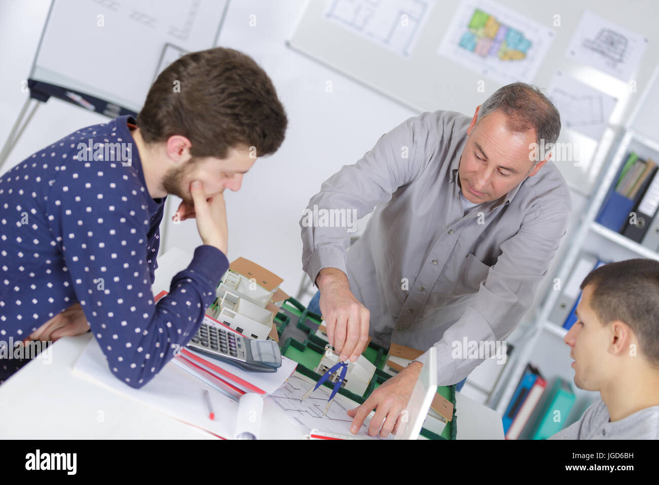 teacher helps students of math class Stock Photo - Alamy