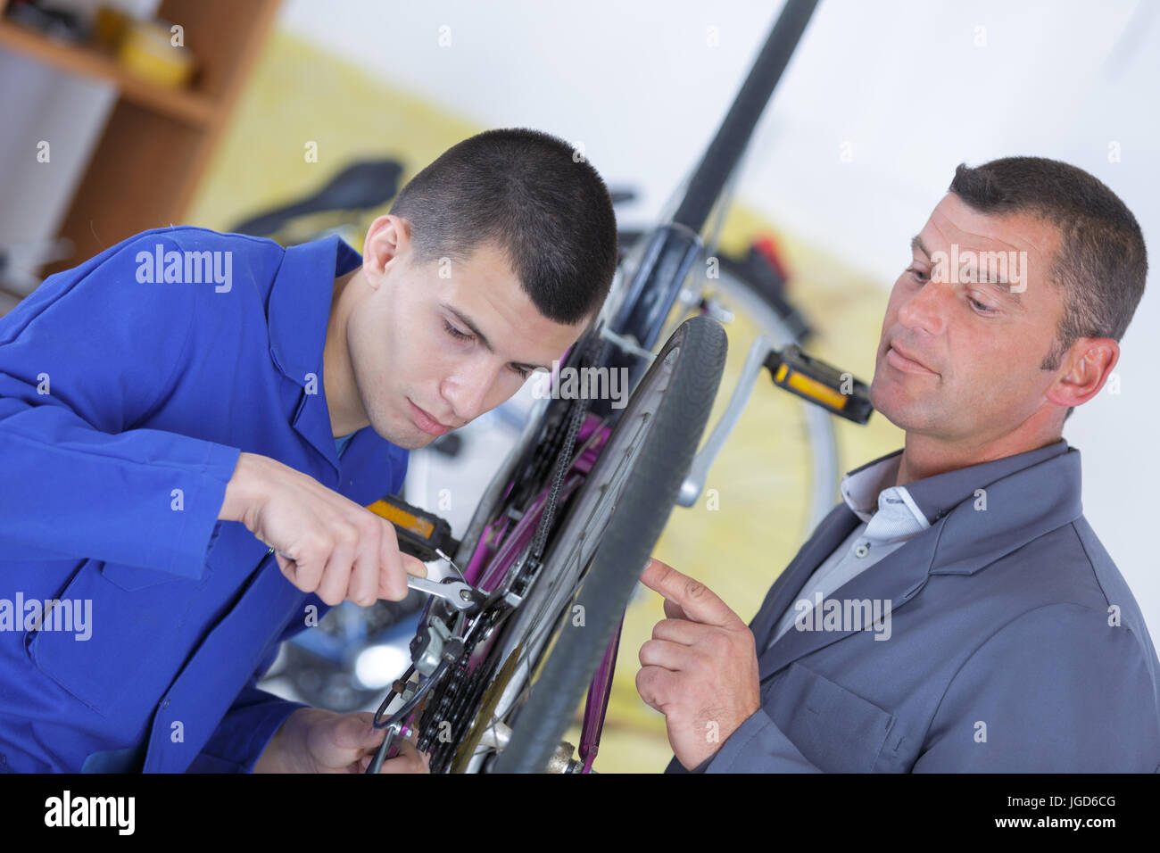 bicycle mechanic setting chain strength on bike Stock Photo - Alamy