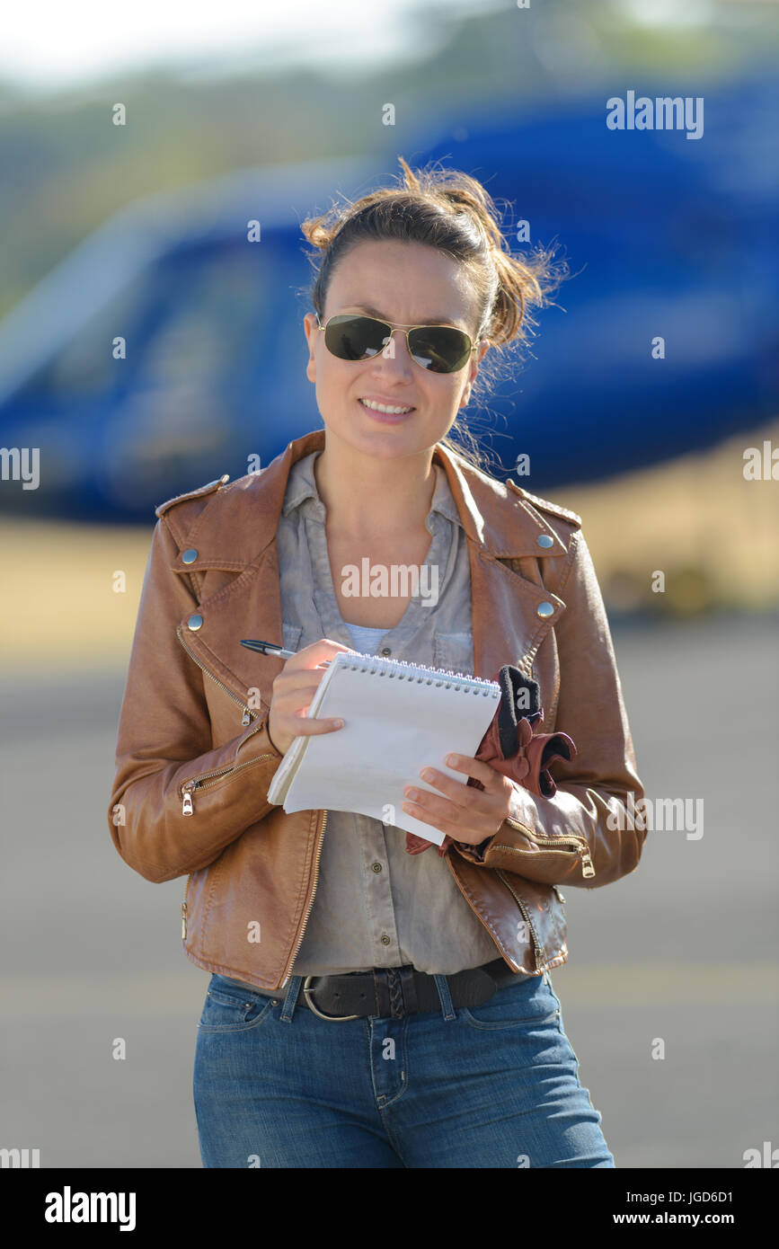 pretty pilot woman on helicopter background Stock Photo - Alamy