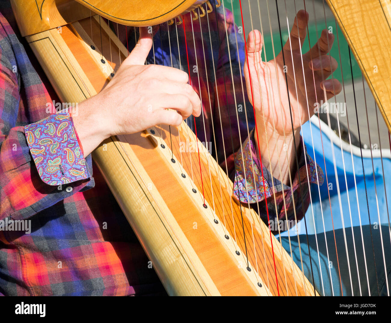 Busker/musician playing a harp at street arts festival. UK Stock Photo ...
