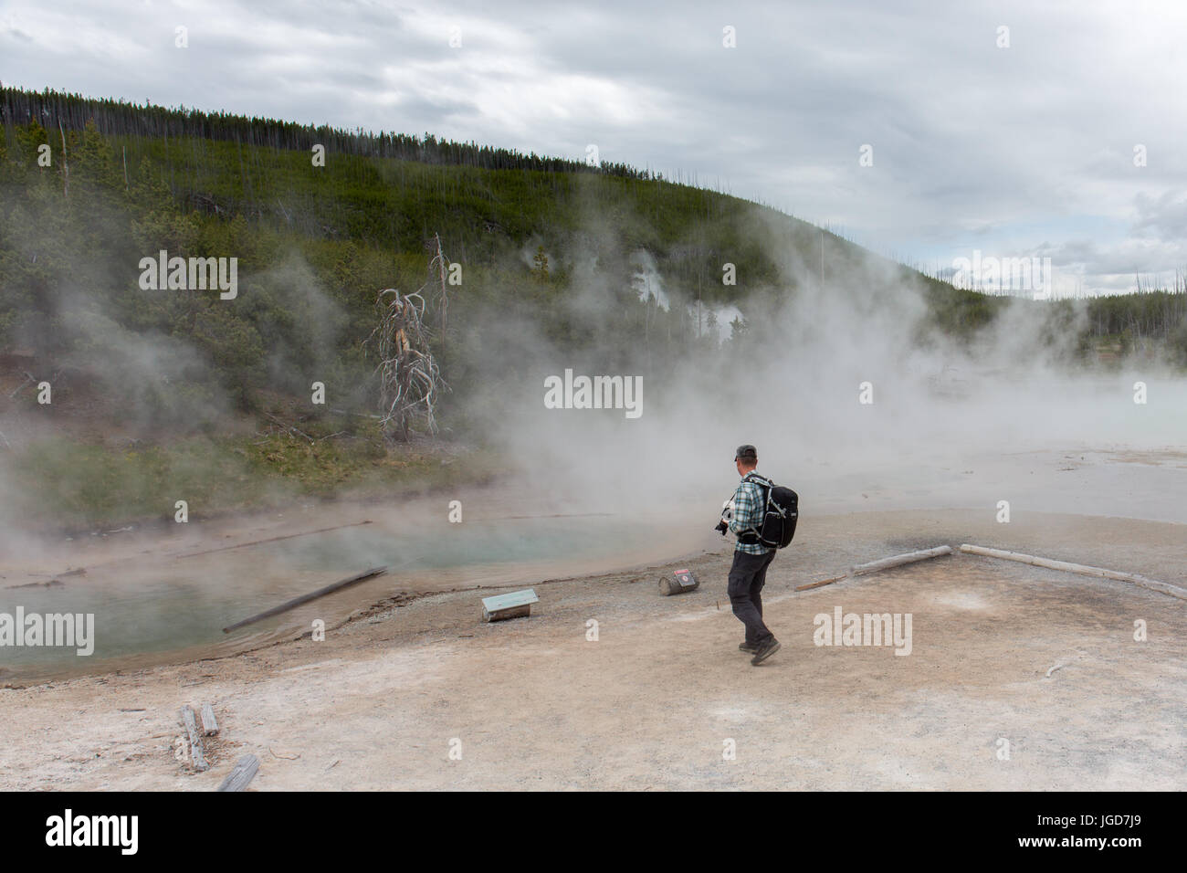 A male photographer at Green Dragon Spring, Back Basin, Norris Geyser ...