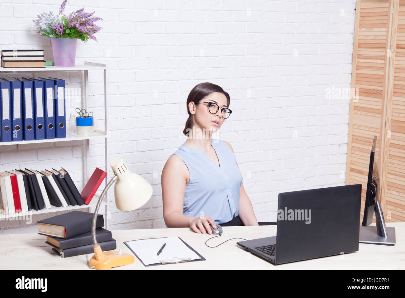 business girl sits at a computer in the Office paper folders Stock ...