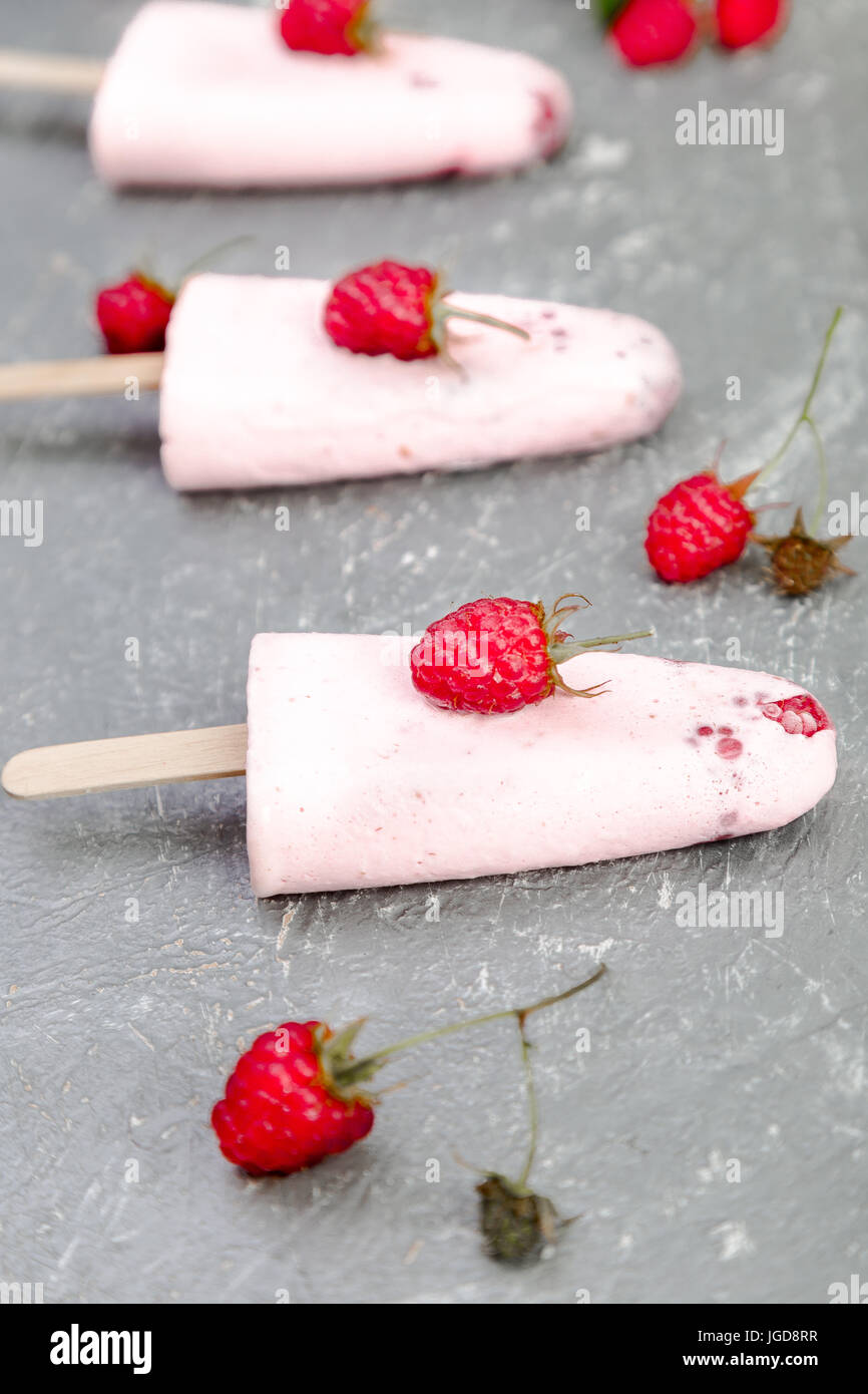 Raspberry ice cream on grey background. Three popsicles. Homemade Stock ...