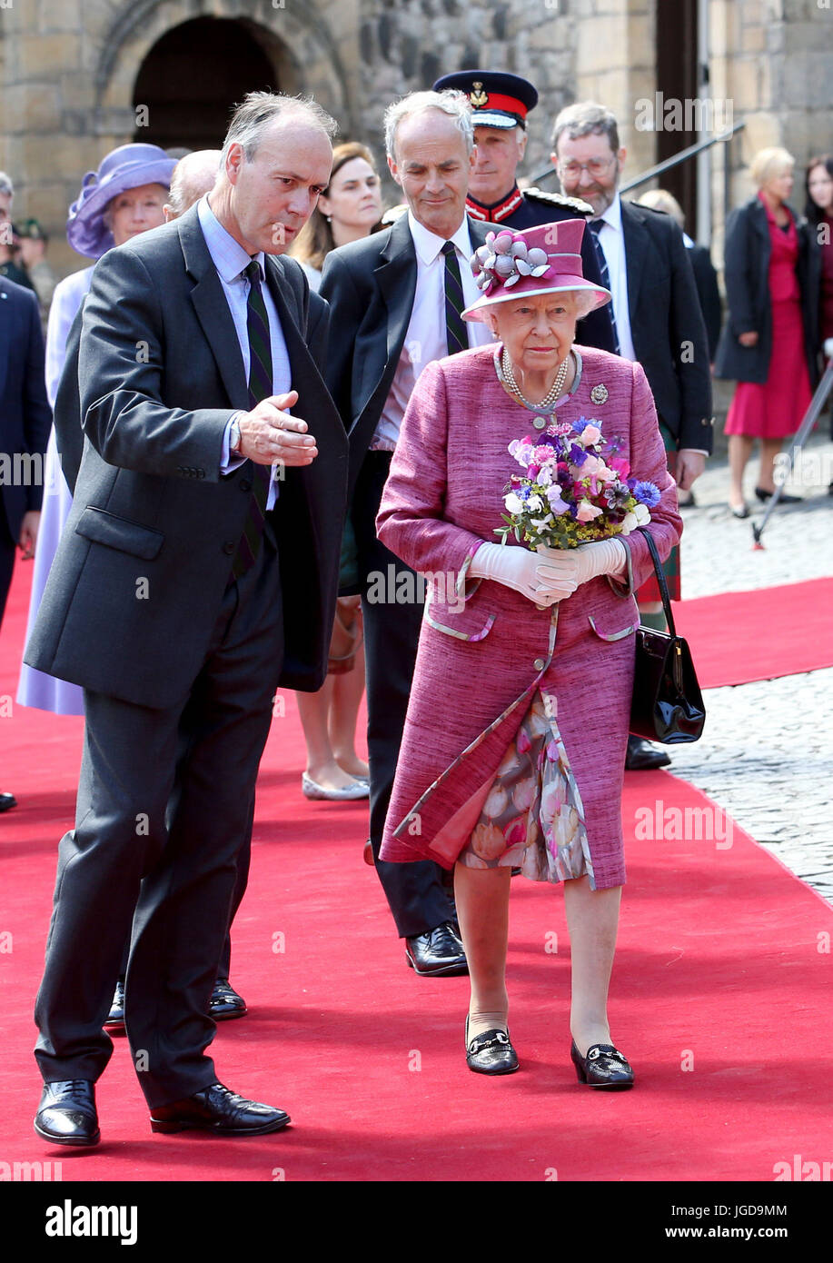 Queen Elizabeth II is escorted by Brigadier Bruce Russell during a ...