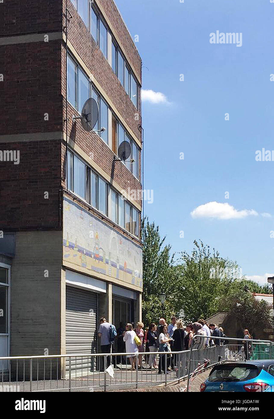 Residents leave a tower block in west London, as the building is ...