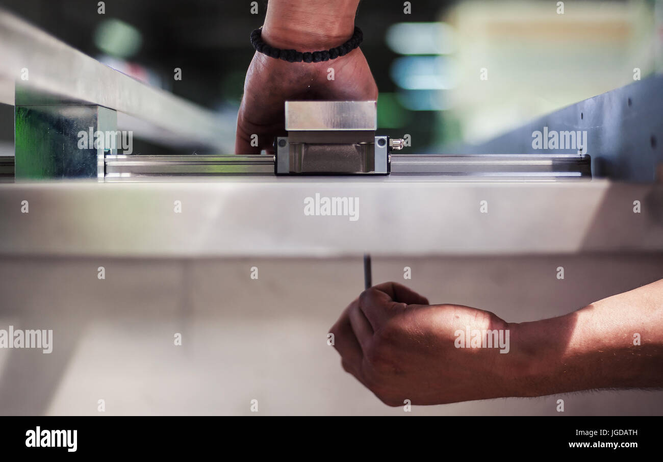 Worker's hands on new machine, conceptual composition about ...