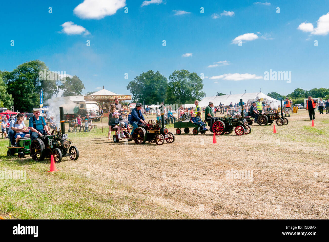Children enjoying a race of miniature scale model traction engines at a ...
