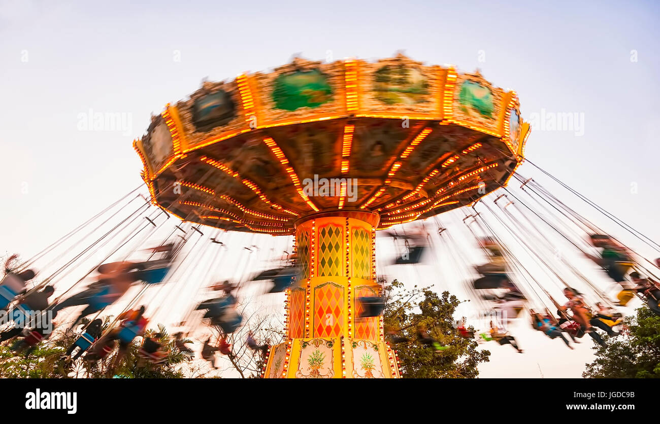 Merry-go-round in an amusement park Stock Photo - Alamy
