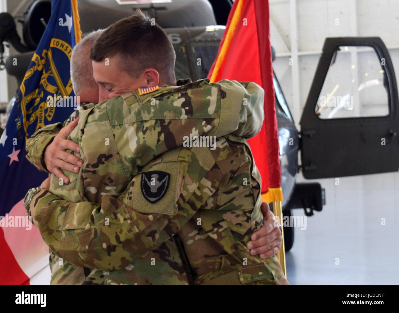 Georgia Army National Guard Lt. Col. James McNair hugs his son Spc ...