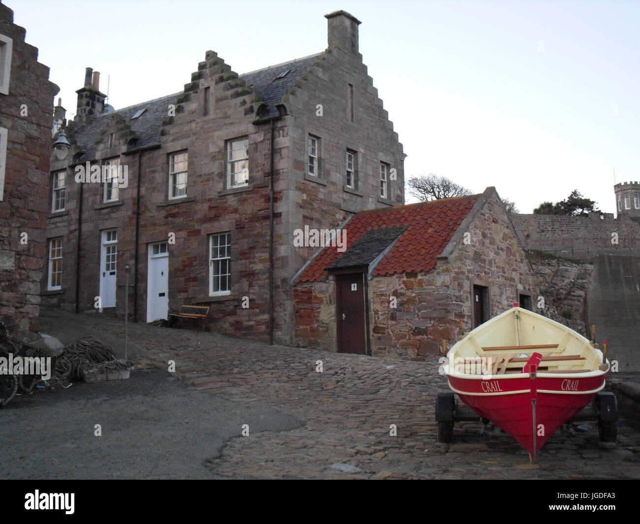 Crail Harbour red boat Stock Photo - Alamy