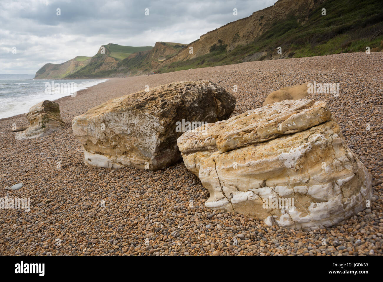 Costal seaside view with large rocks in foreground on a cloudy day ...