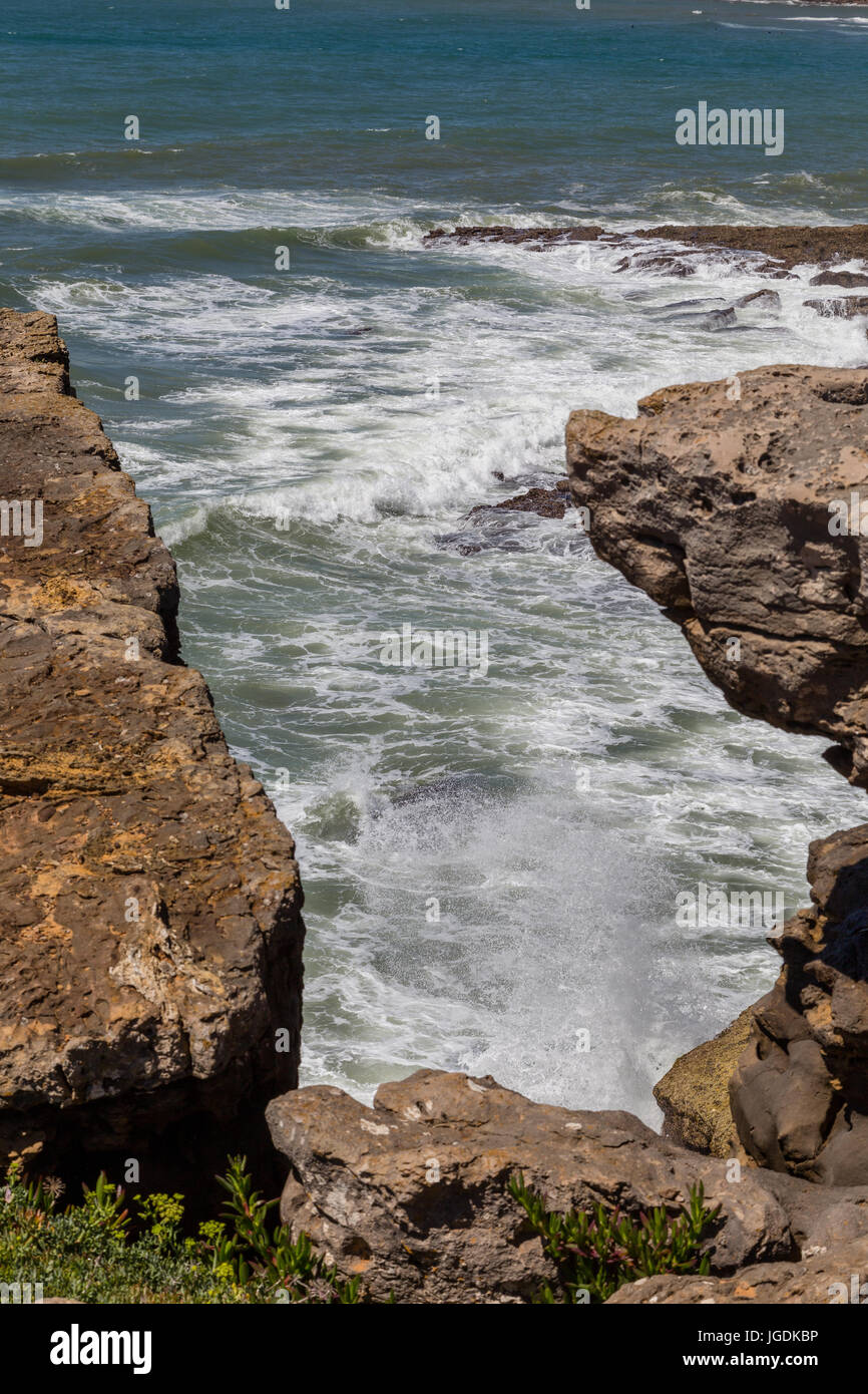view on coast line rocks in ocean with splash waves Stock Photo - Alamy