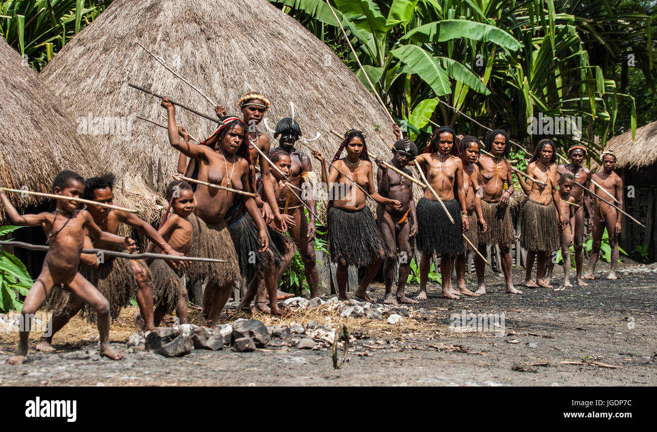 DANI VILLAGE, WAMENA, IRIAN JAYA, NEW GUINEA, INDONESIA – 15 MAY 2012: Women and children Dani ...