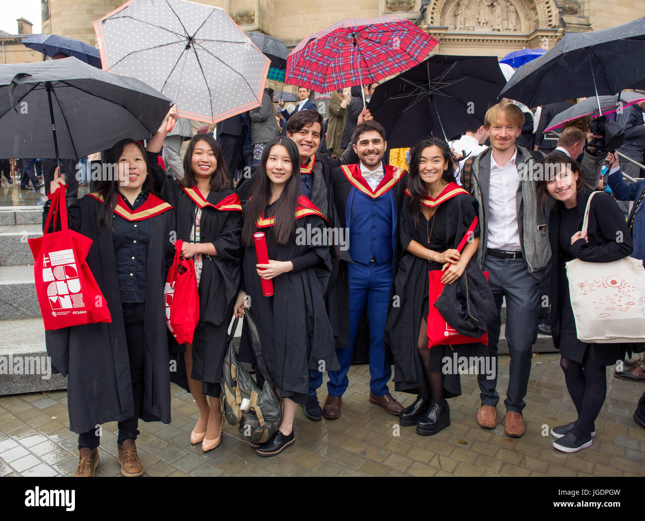 Edinburgh University students shelter from the rain after a graduation ...