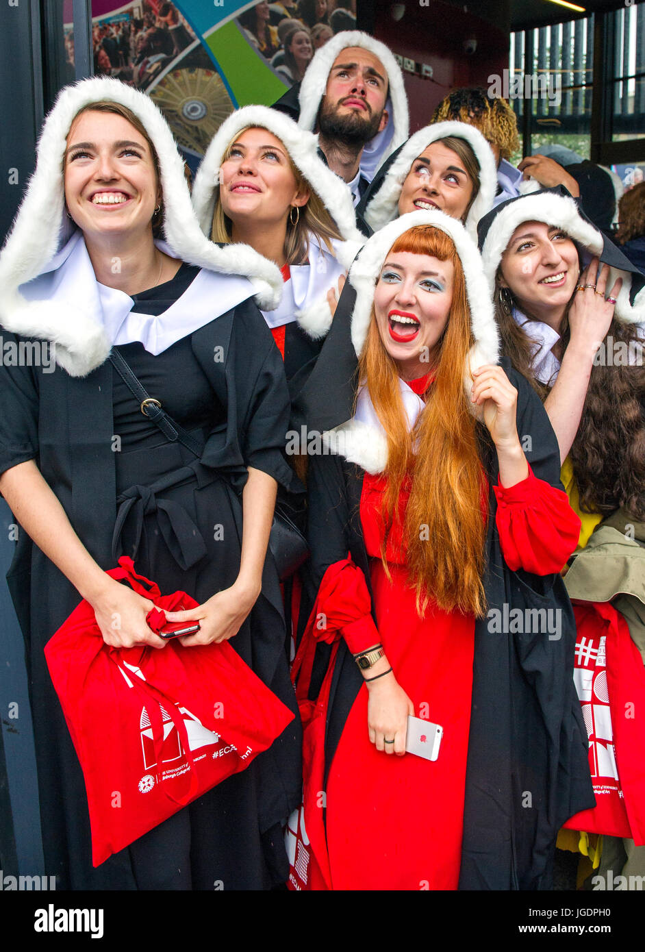 Edinburgh University students shelter from the rain after a graduation ...
