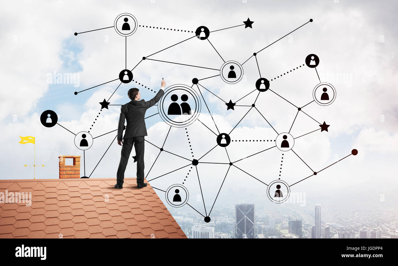 Businessman on house roof presenting networking and connection concept ...