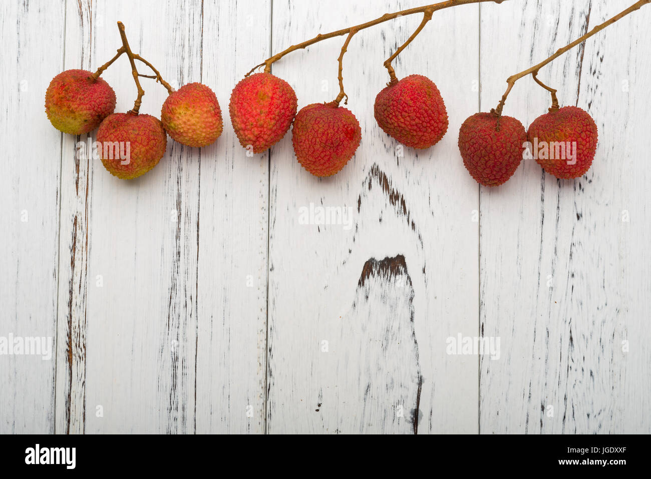 fresh lichees on white wood background with copy space Stock Photo - Alamy