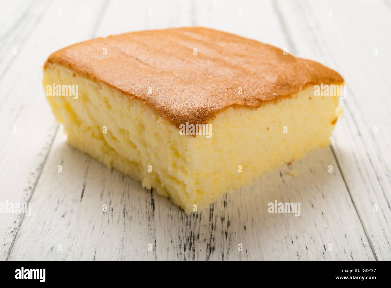 side view sponge cake on white wood background Stock Photo - Alamy