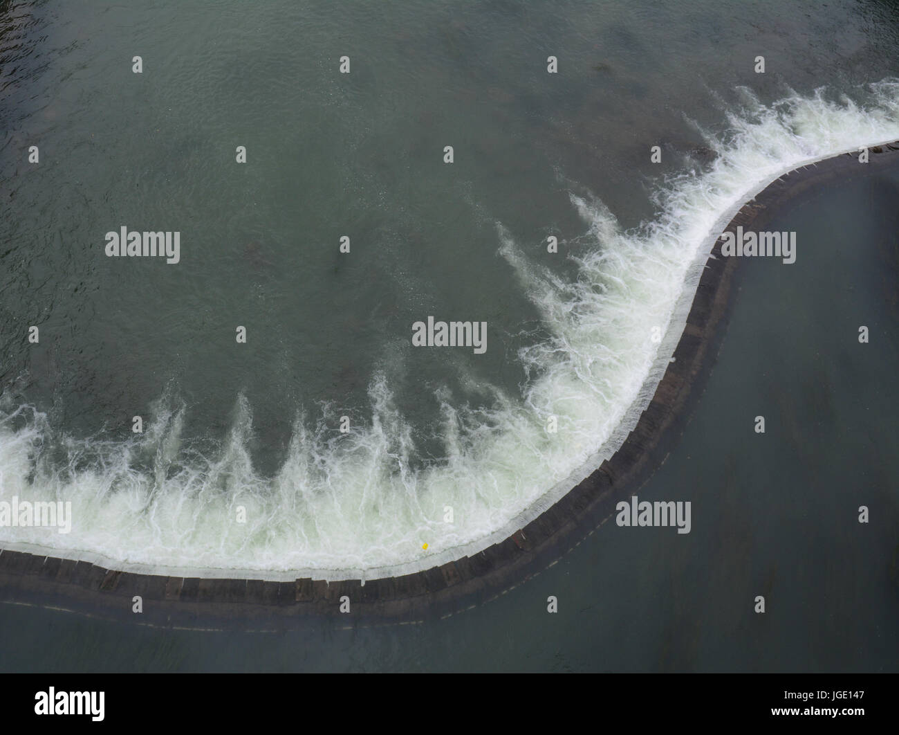 Small dam on the river at rainy day. Close up Stock Photo - Alamy