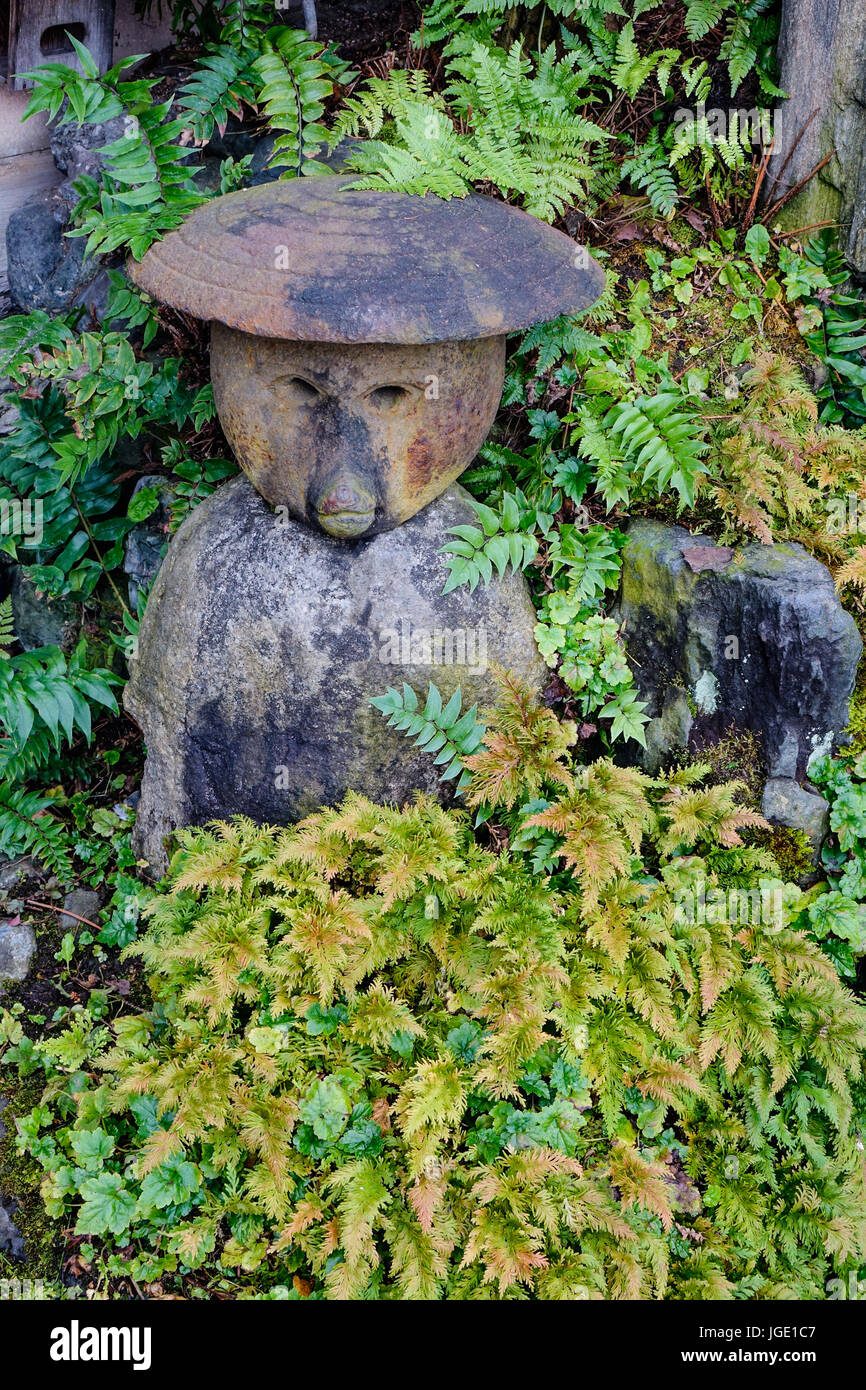Decorations in Japanese garden with a statue on the grass Stock Photo ...