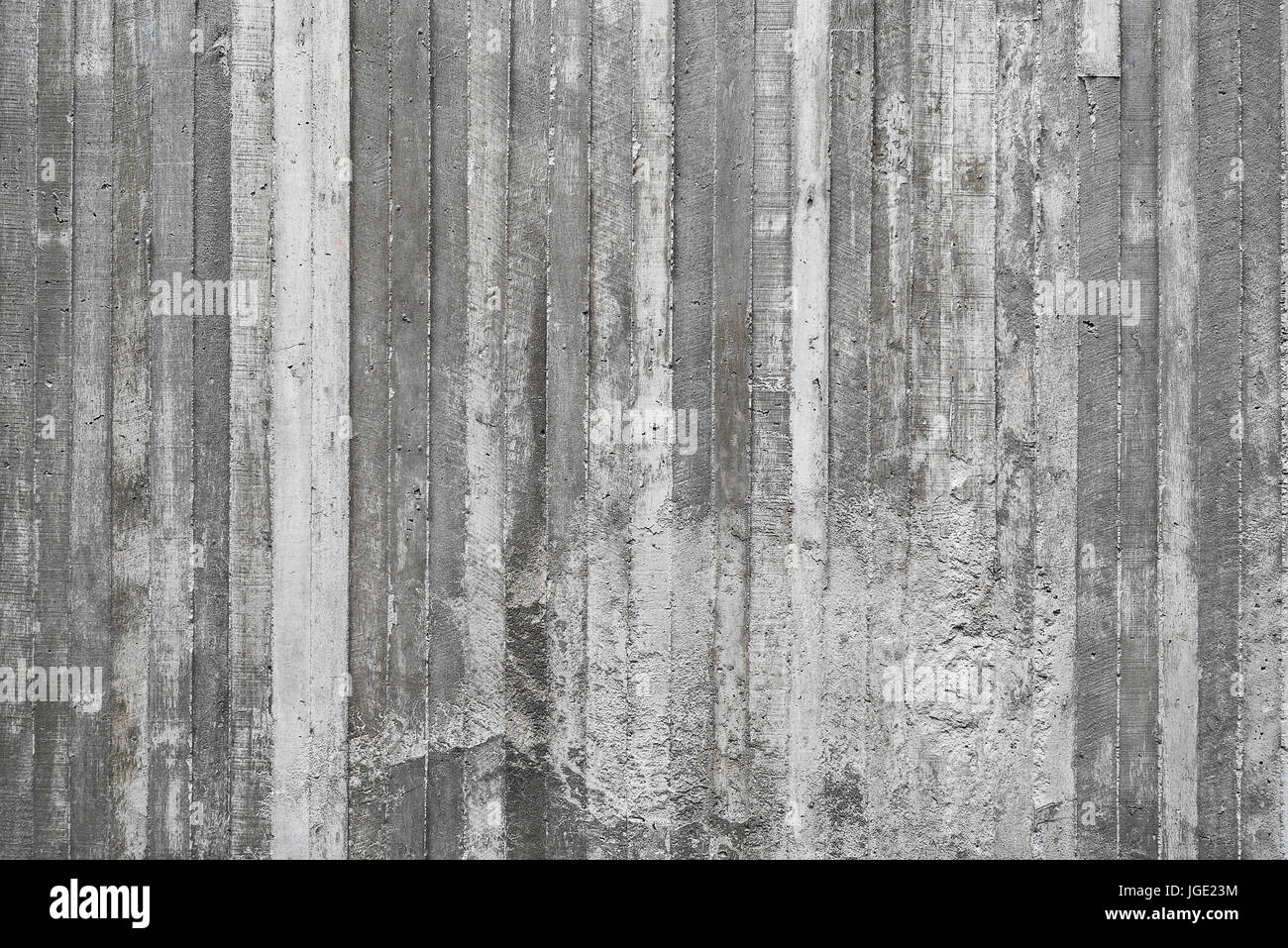 texture of wooden formwork stamped on a raw concrete wall as background ...
