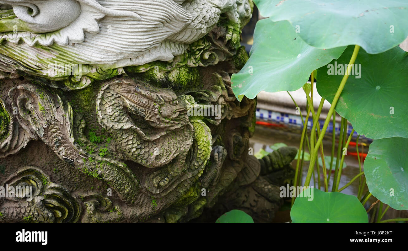 Chinese dragon statue with lotus plants for decoration at the park ...