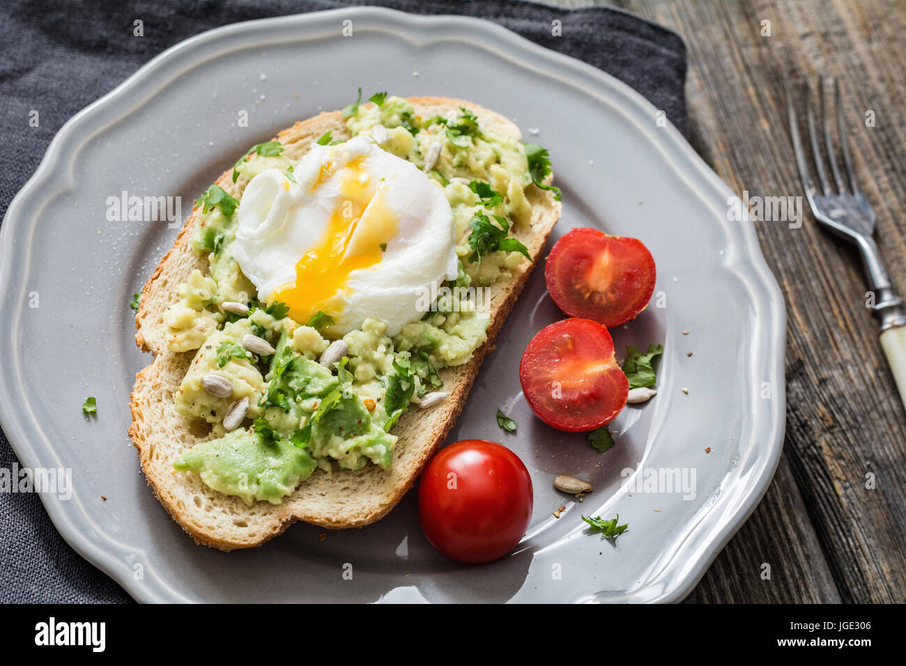 Poached egg on avocado toast. Delicious and healthy snack: mashed ...