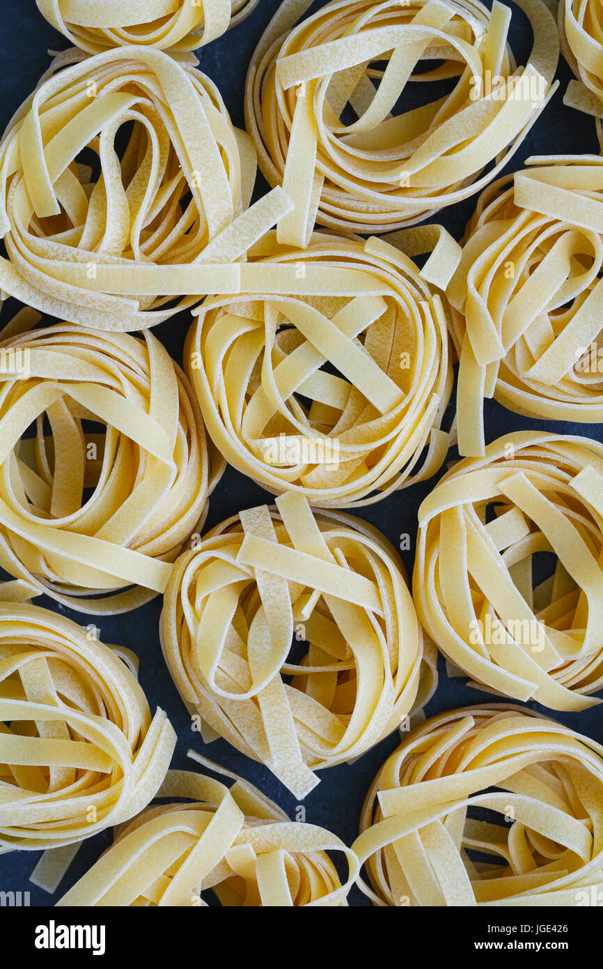 Top view on uncooked nests of tagliatelle pasta Stock Photo - Alamy