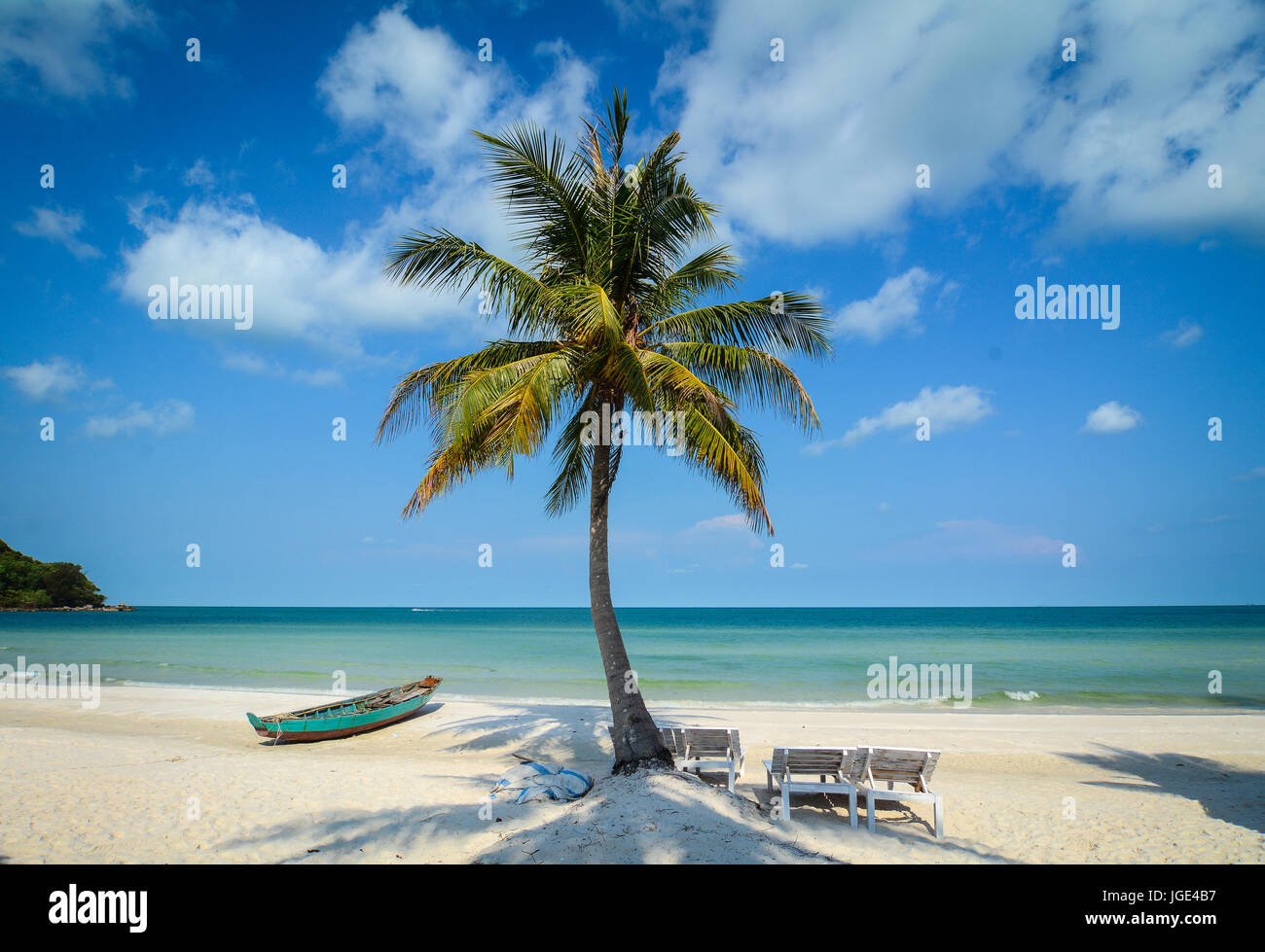 White sand beach with coconut tree and a boat in Phu Quoc Island ...
