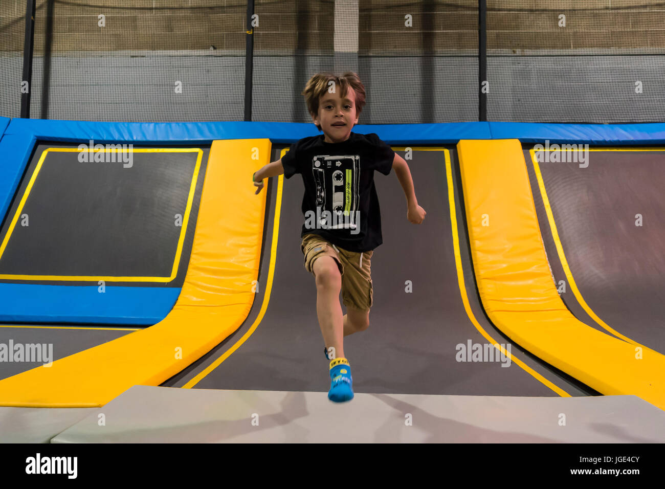 Boy running in adventure playground Stock Photo - Alamy