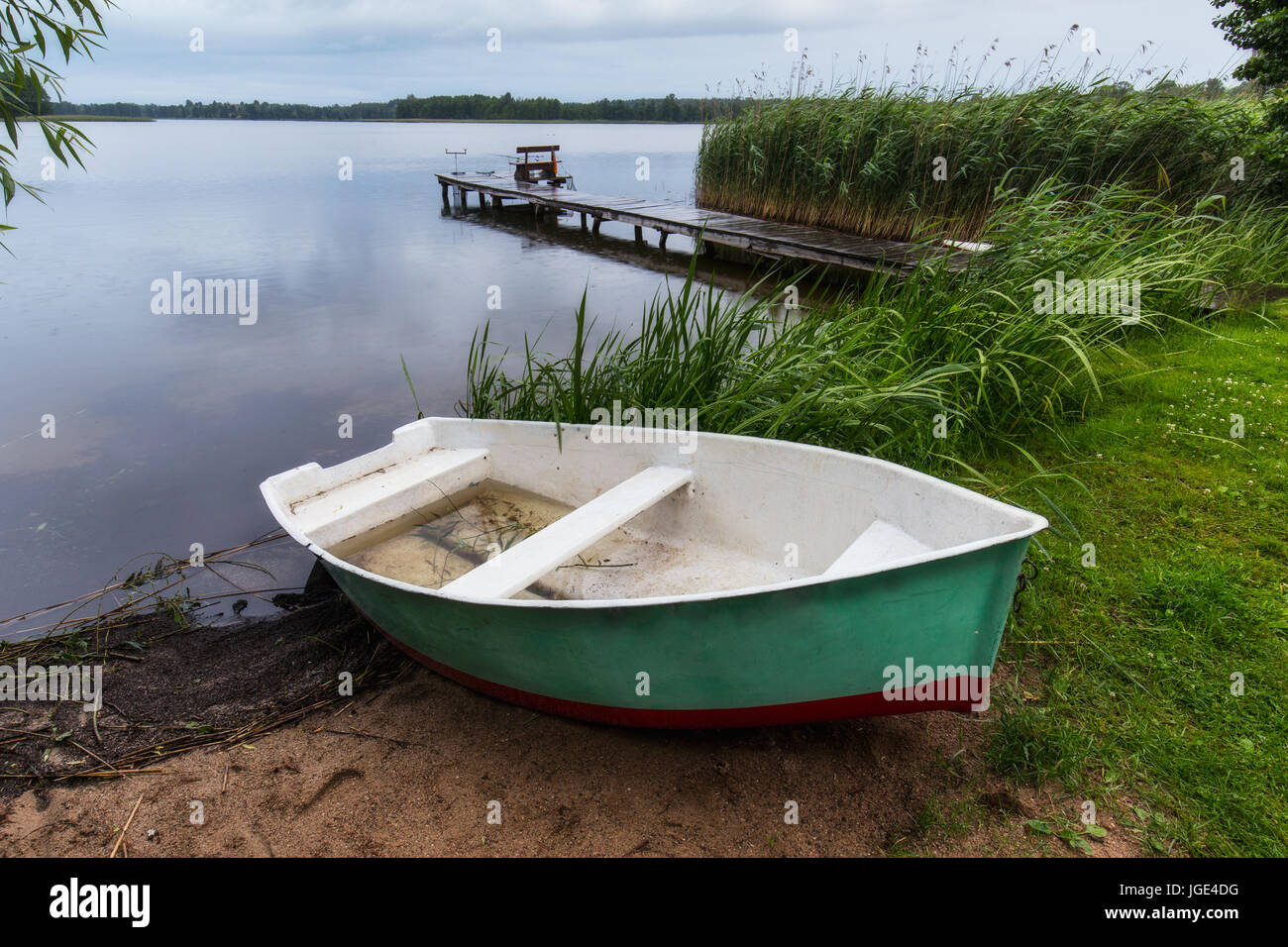 Fisherman's boat and bridge with fishing poles in rainy evening at ...