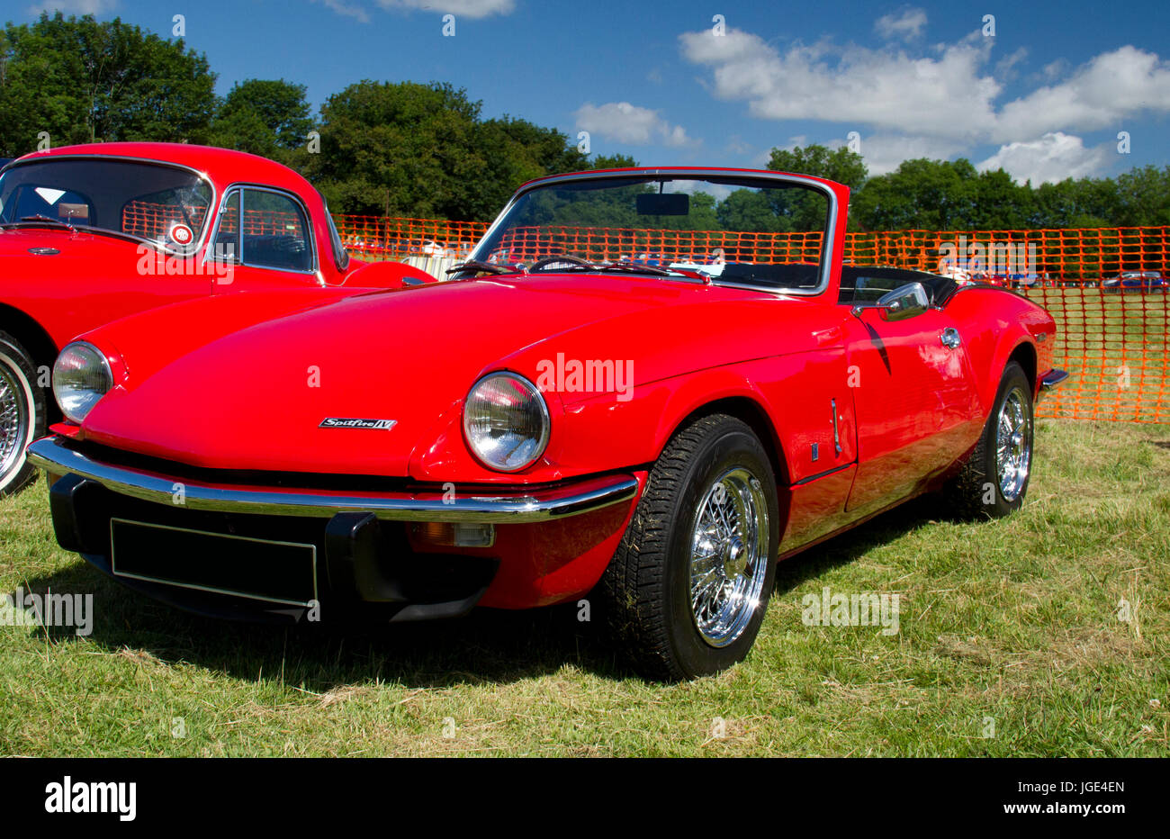 Front view of a bright red Triumph Sptifire sports car on display at a ...
