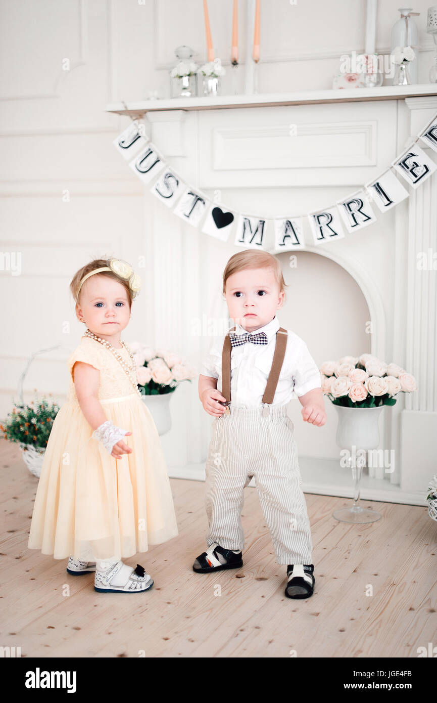 two babies - boy and girl dressed as bride and groom Stock Photo - Alamy