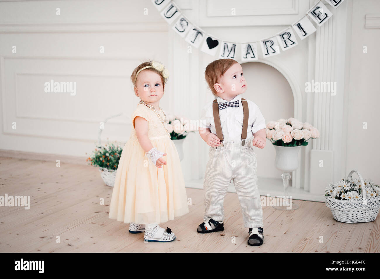 two babies - boy and girl dressed as bride and groom Stock Photo - Alamy